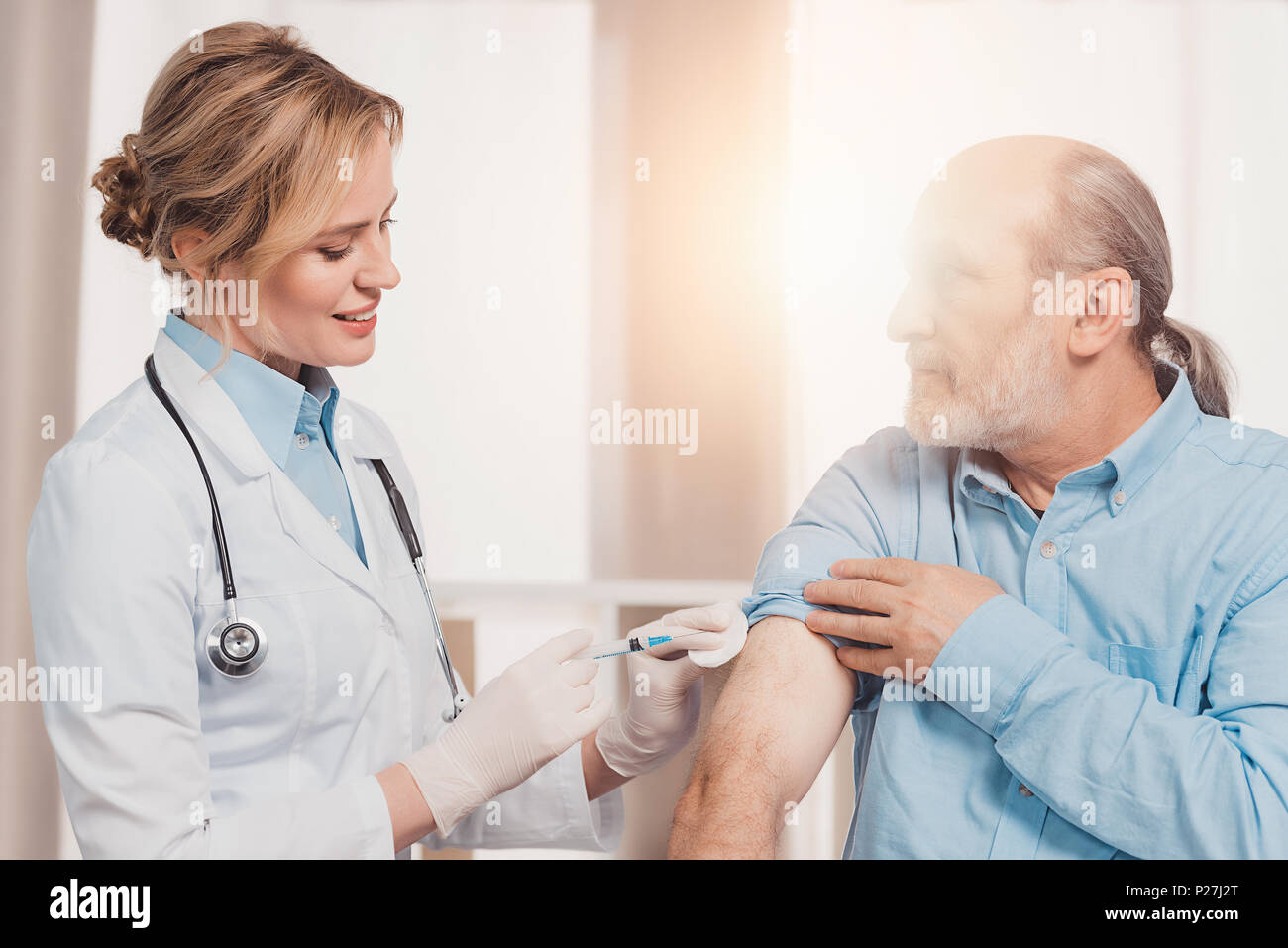 Professional doctor making injection caucasian hi-res stock photography ...