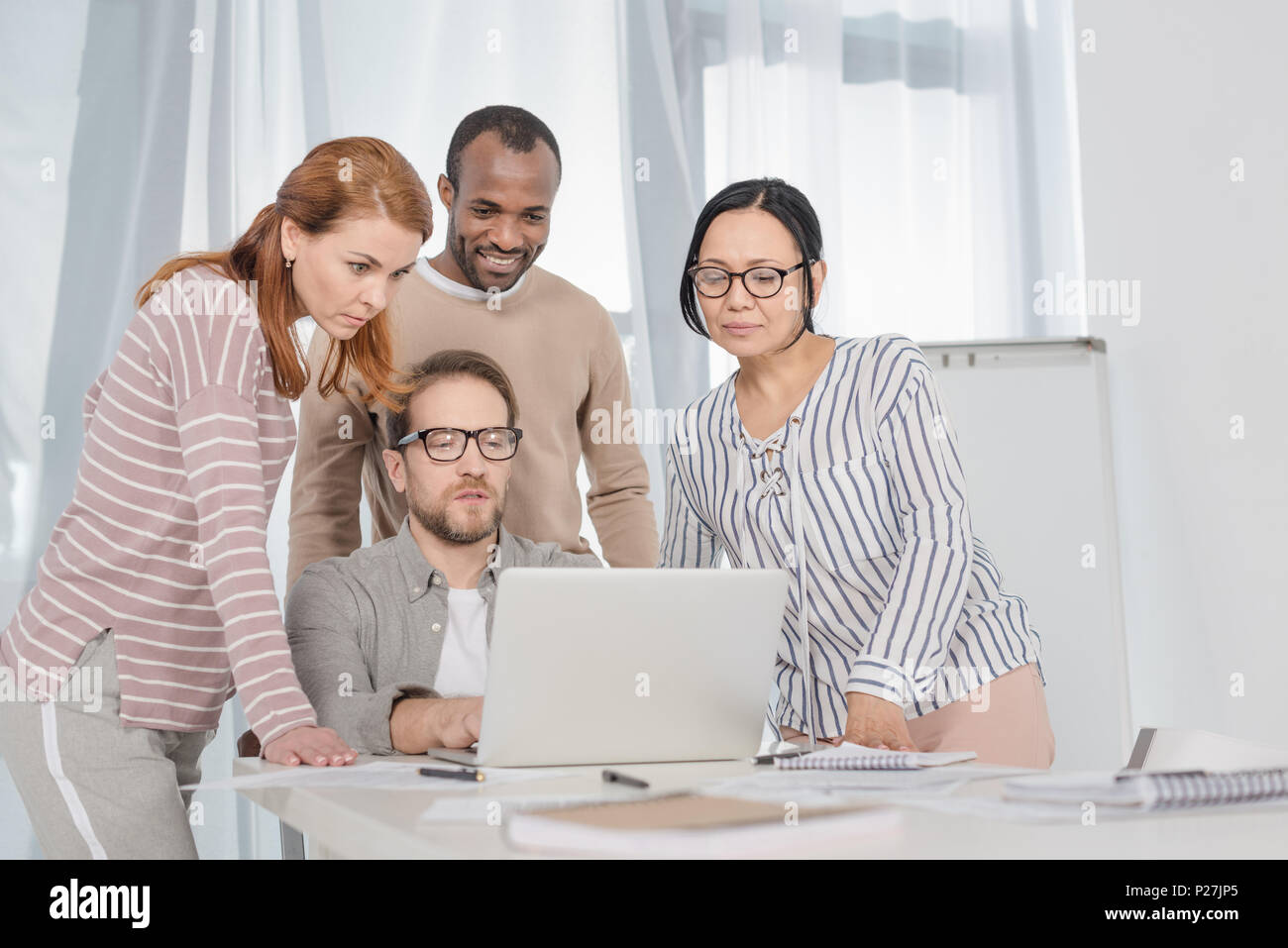 middle aged multiethnic group of people using laptop together Stock ...