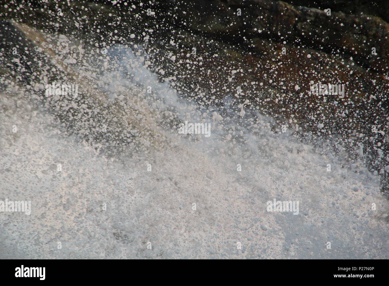 Waves hit the rocks causing amazingly powerful splashes Stock Photo - Alamy