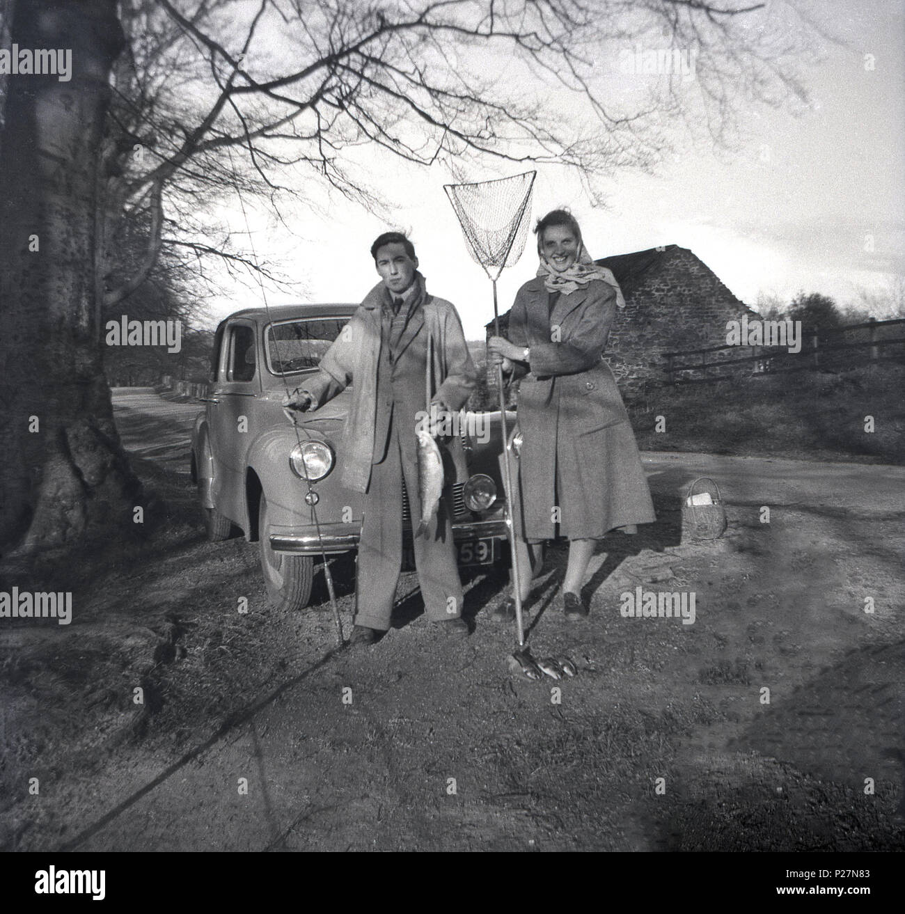 1950s, historical, going fishing...a man and lady standing by their car ...