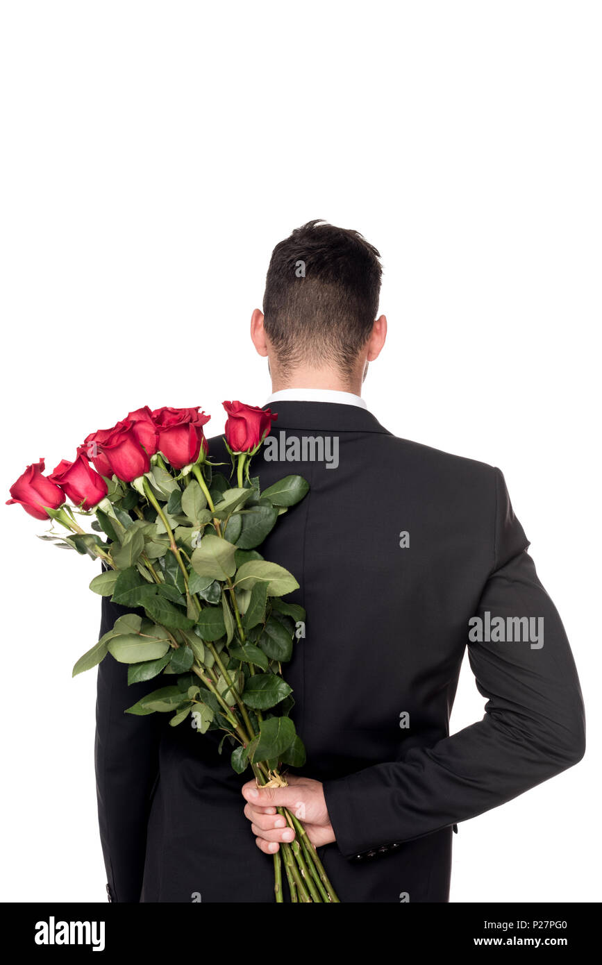 rear view of man hiding bouquet of roses isolated on white Stock Photo ...