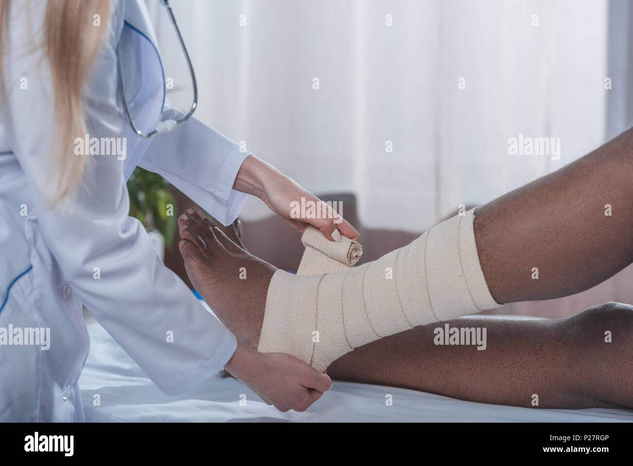 Female doctor bandaging hands hi-res stock photography and images - Alamy