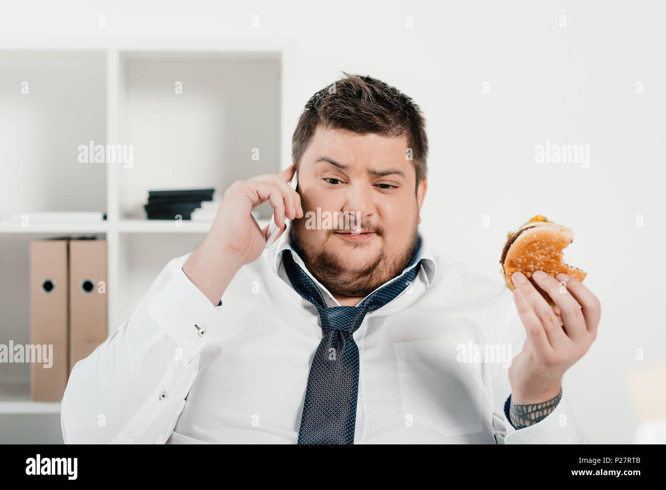 Fat man eating hamburger on hi-res stock photography and images - Alamy