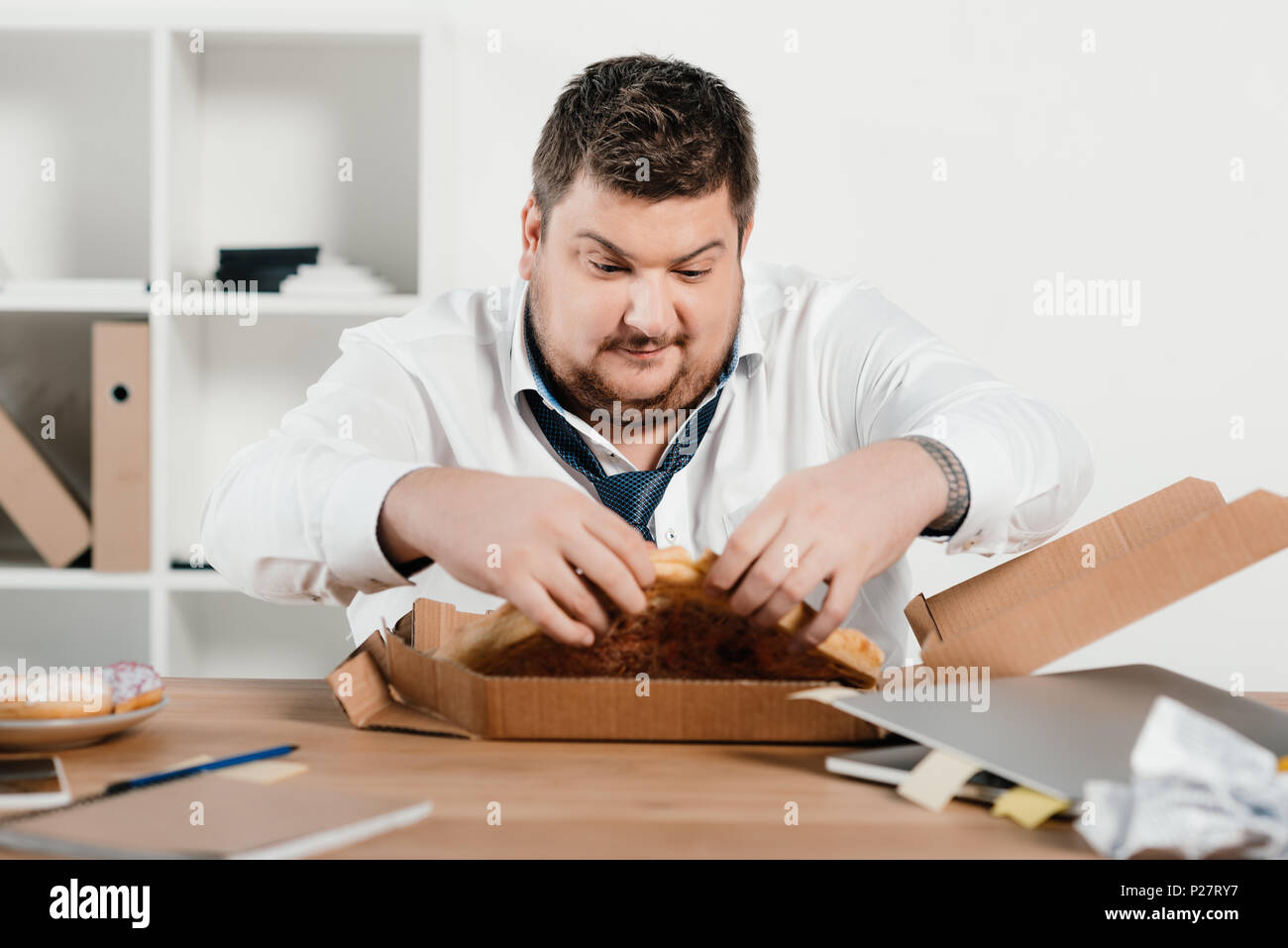 Fat man eating pizza hi-res stock photography and images - Alamy