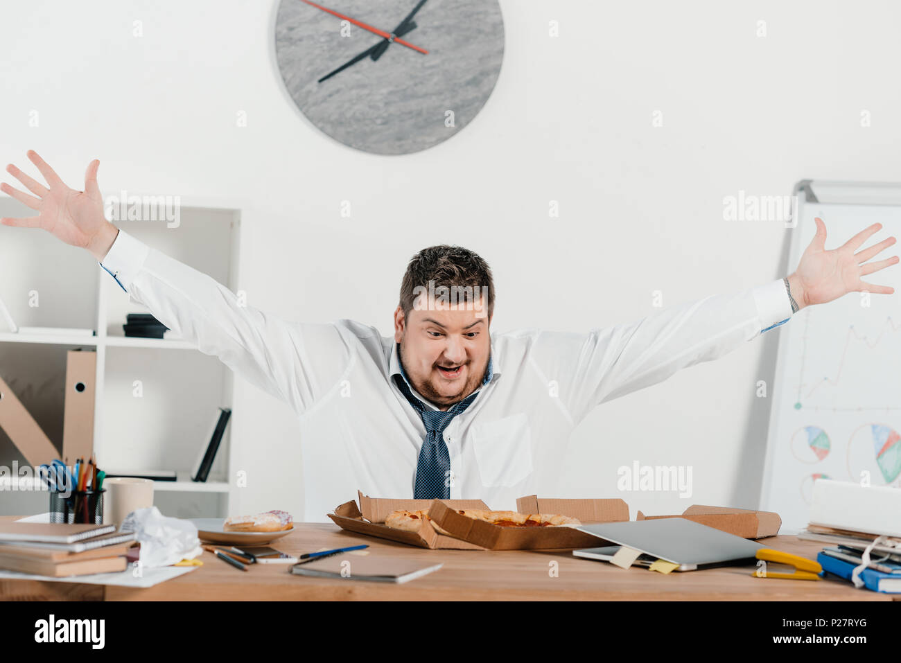 Overweight man eating in office hi-res stock photography and images - Alamy