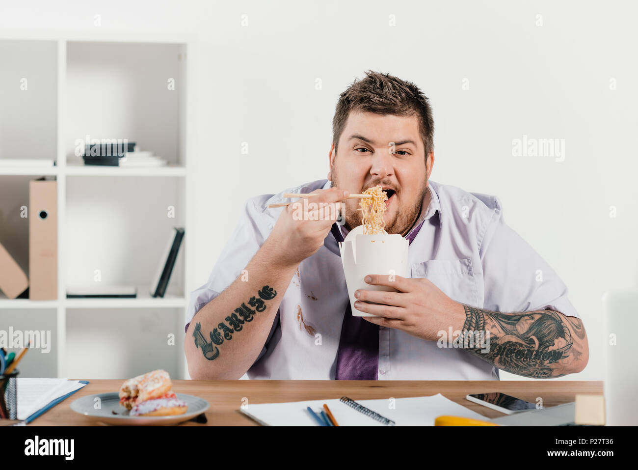 Overweight man eating in office hi-res stock photography and images - Alamy