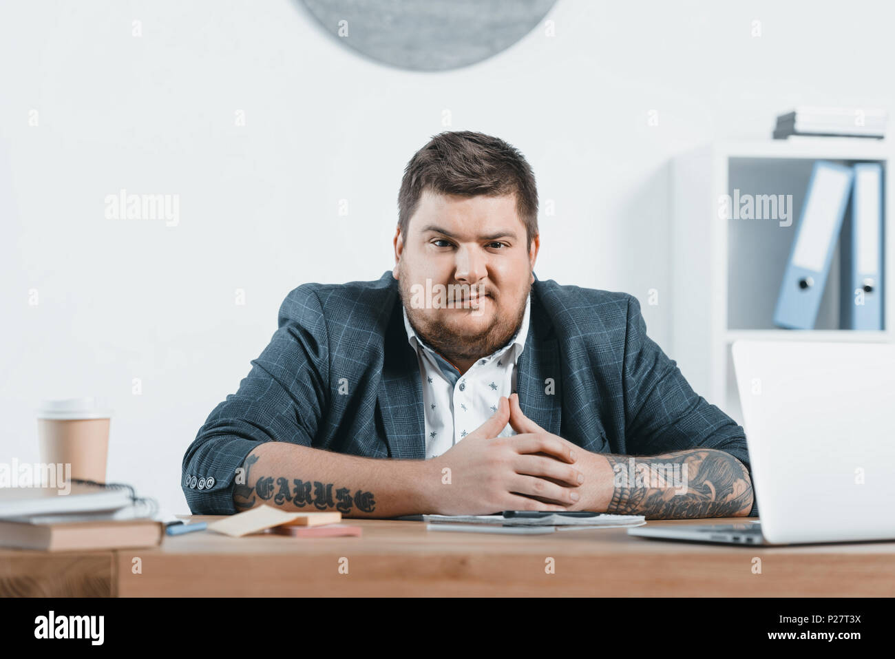 confident overweight businessman sitting at workplace in office Stock ...