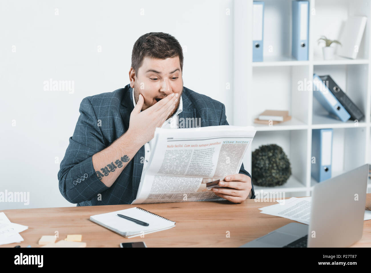 Fat man reading newspaper hi-res stock photography and images - Alamy