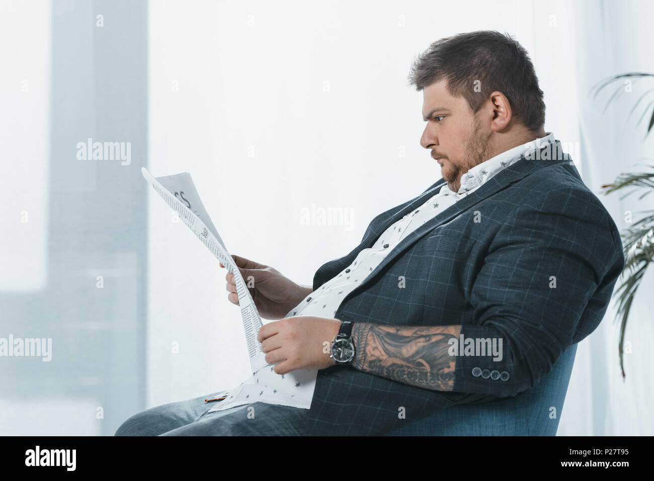 Fat man reading newspaper hi-res stock photography and images - Alamy