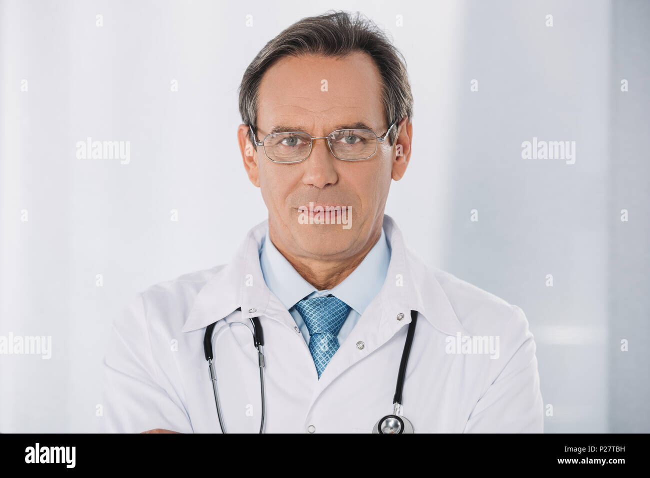 portrait of doctor standing and looking at camera Stock Photo - Alamy