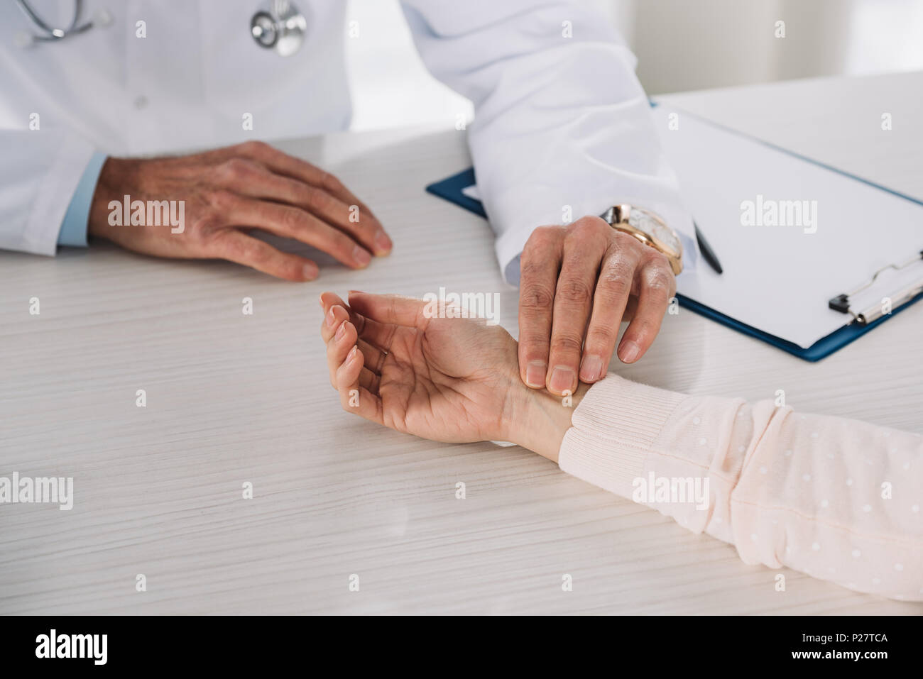 cropped image of doctor measuring female patient pulse Stock Photo - Alamy