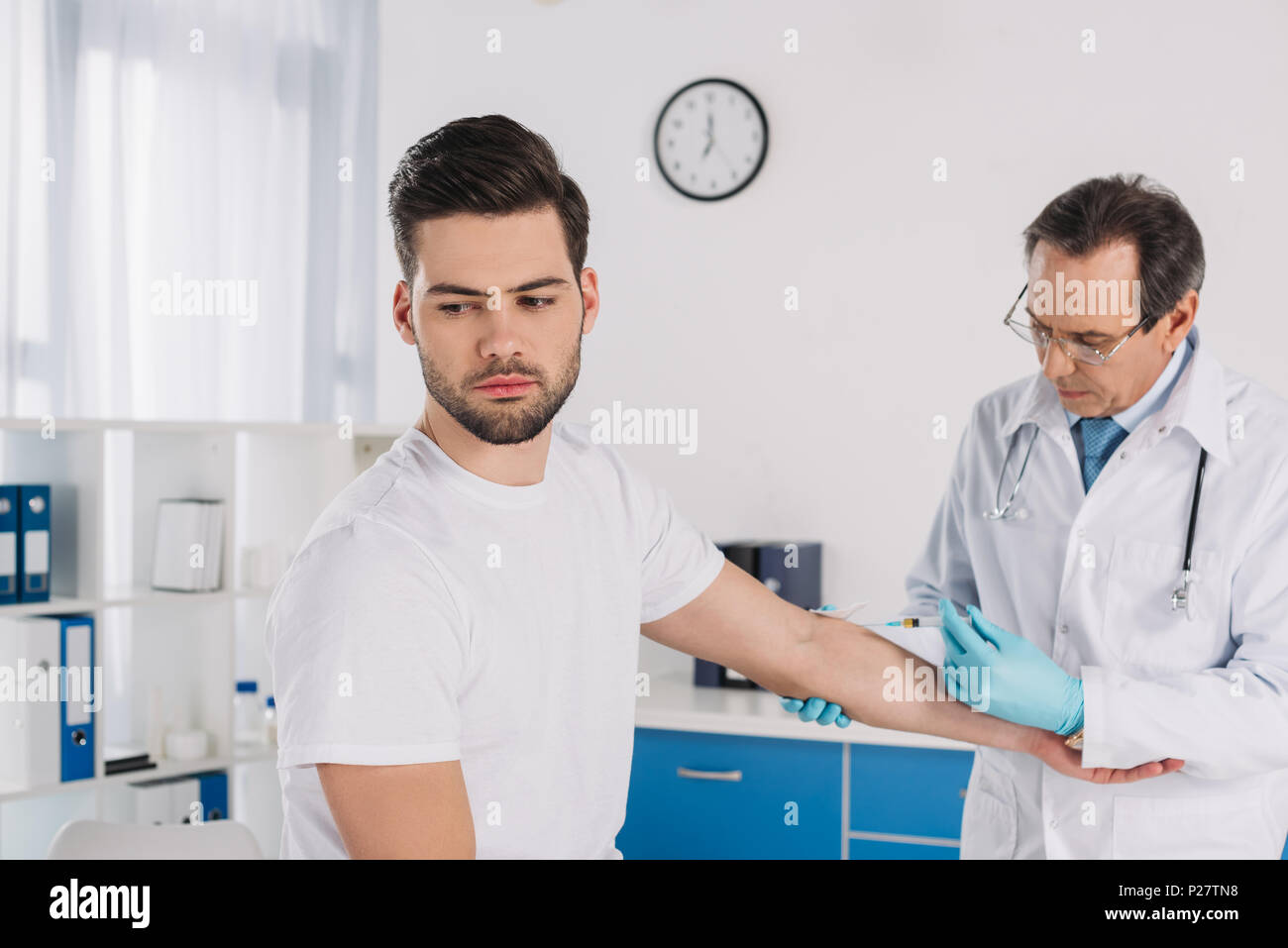 doctor taking patient blood for test Stock Photo - Alamy