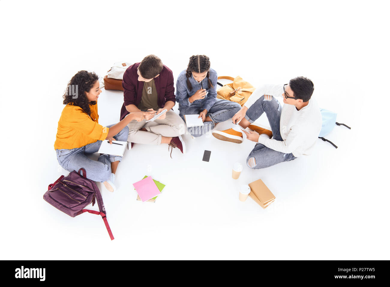 high angle view of multiracial students doing homework together ...