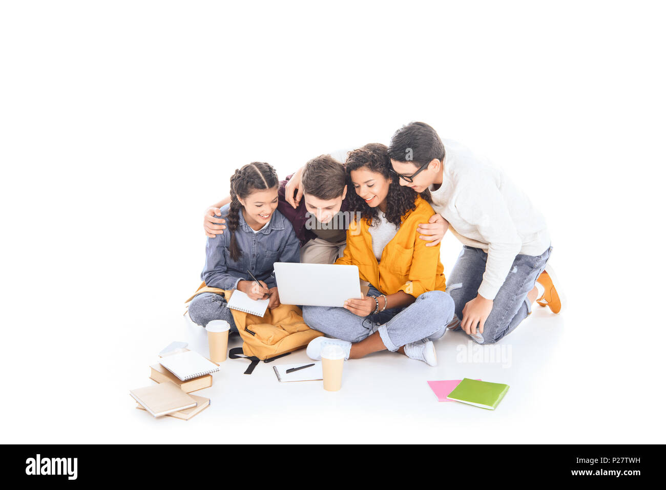 smiling multiethnic students using laptop together isolated on white ...