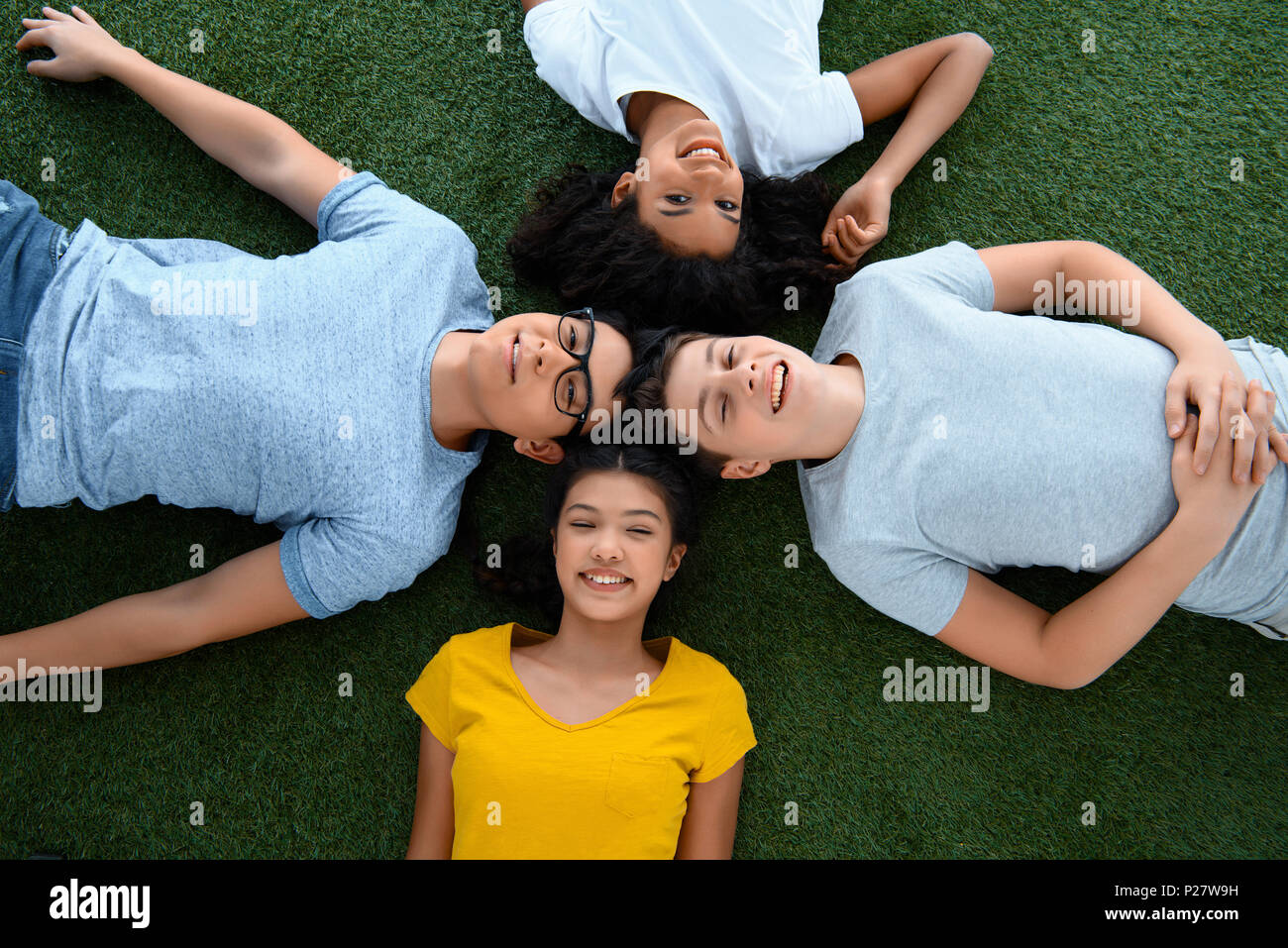 top view of group of teens relaxing on green grass Stock Photo - Alamy