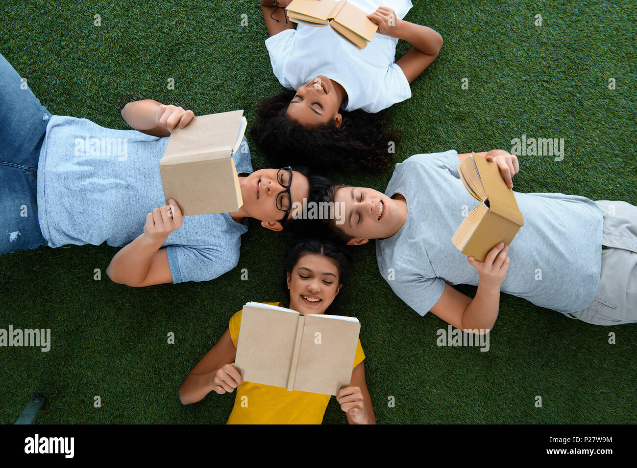 top view of group of teen students reading books on green grass Stock ...