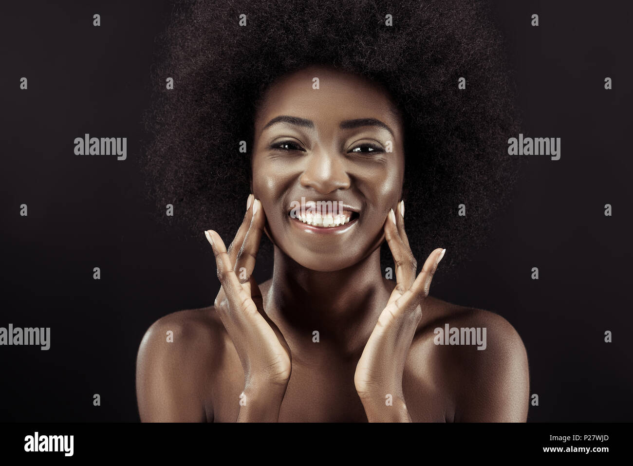 beautiful african american woman touching face with hands isolated on ...