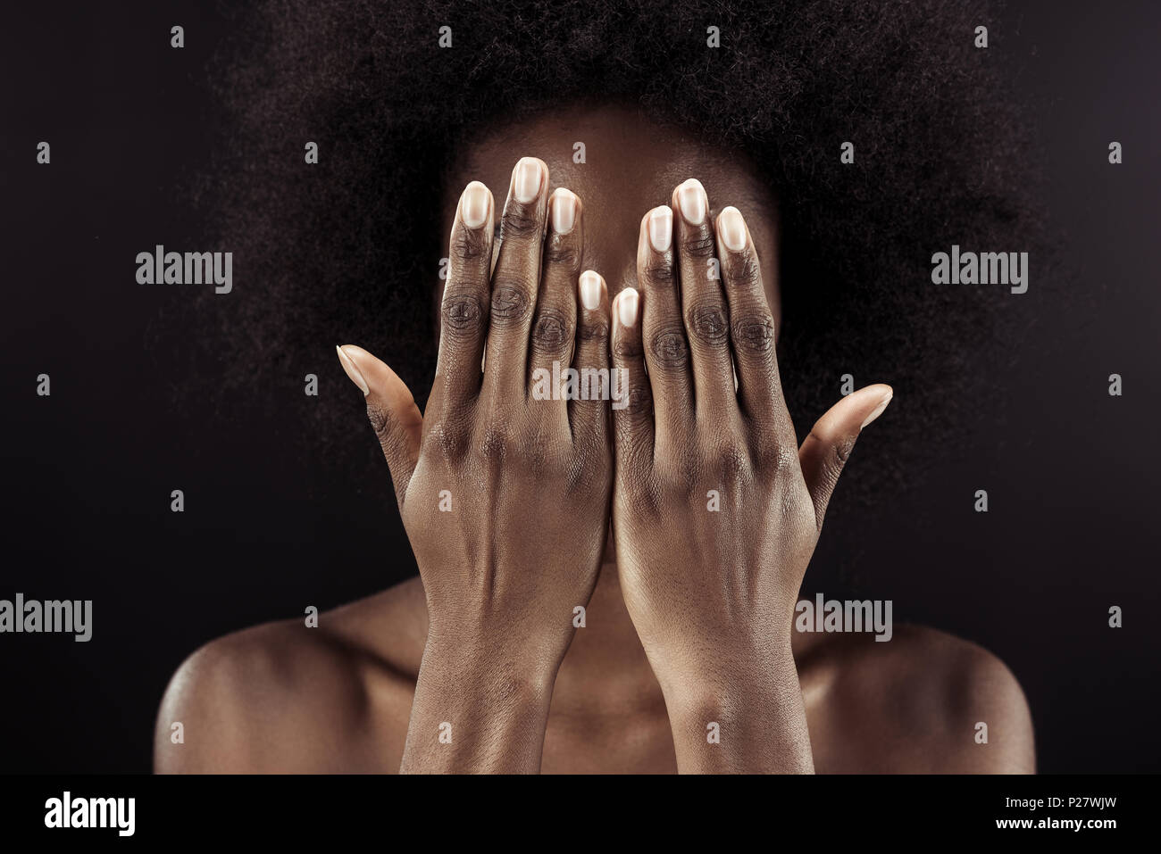 african american woman covering face with hands isolated on black Stock ...