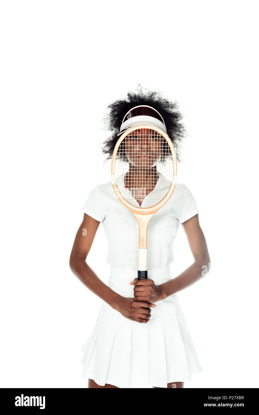 young female tennis player holding racket in front of face isolated on ...
