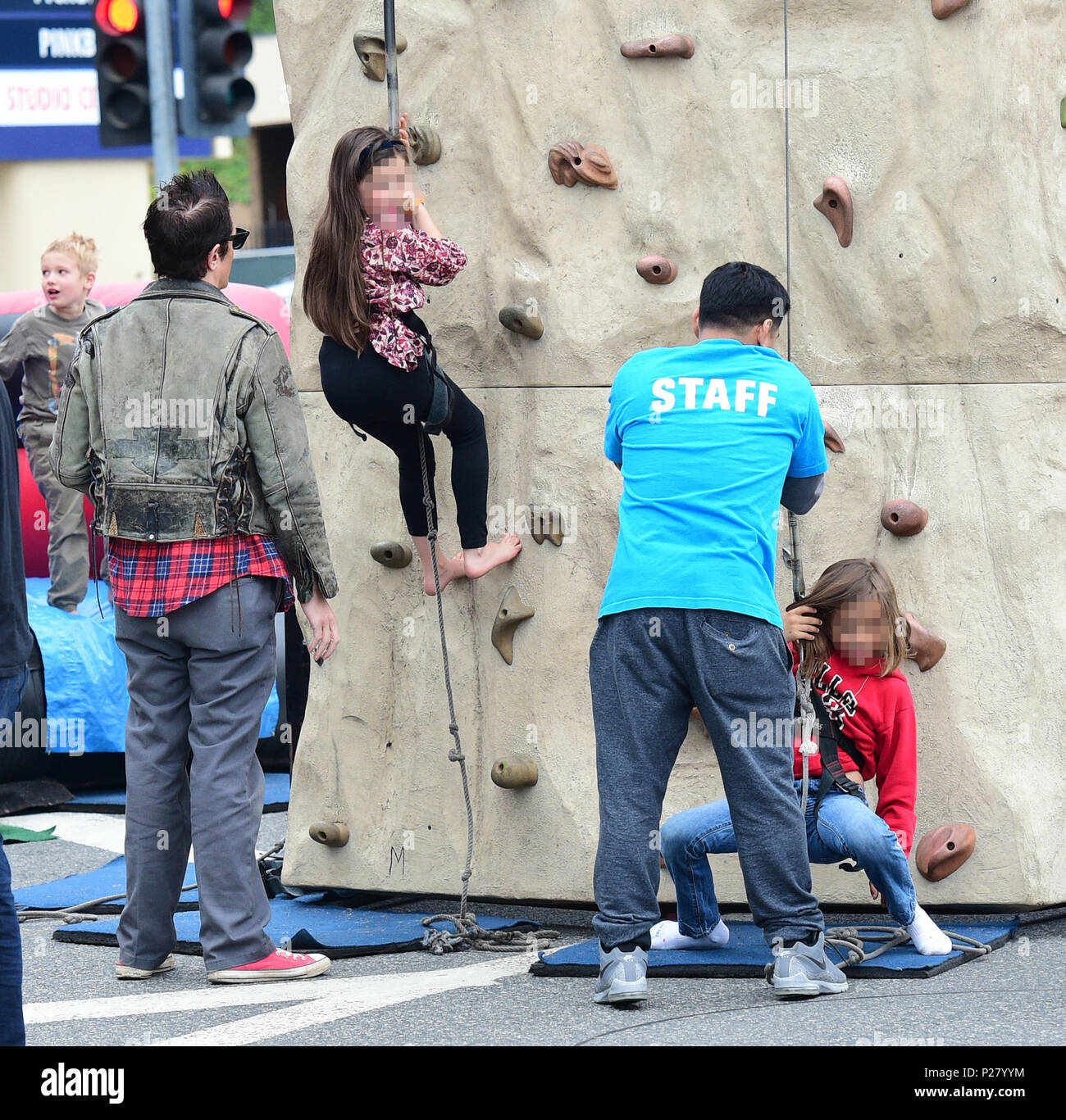 Johnny Knoxville watches his children play on a climbing wall during a ...