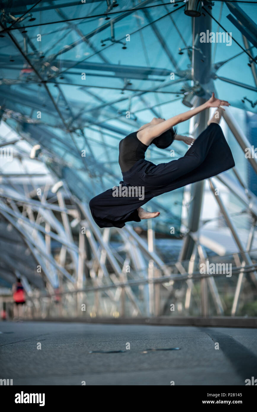 Beautiful Young Girl Dancing on a bridge, wearing black Stock Photo - Alamy