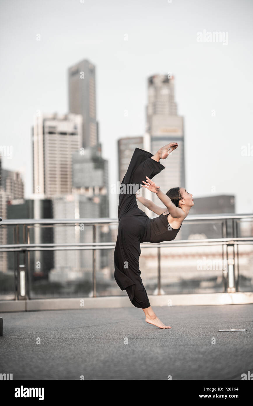 Beautiful Young Girl Dancing on a bridge Stock Photo - Alamy