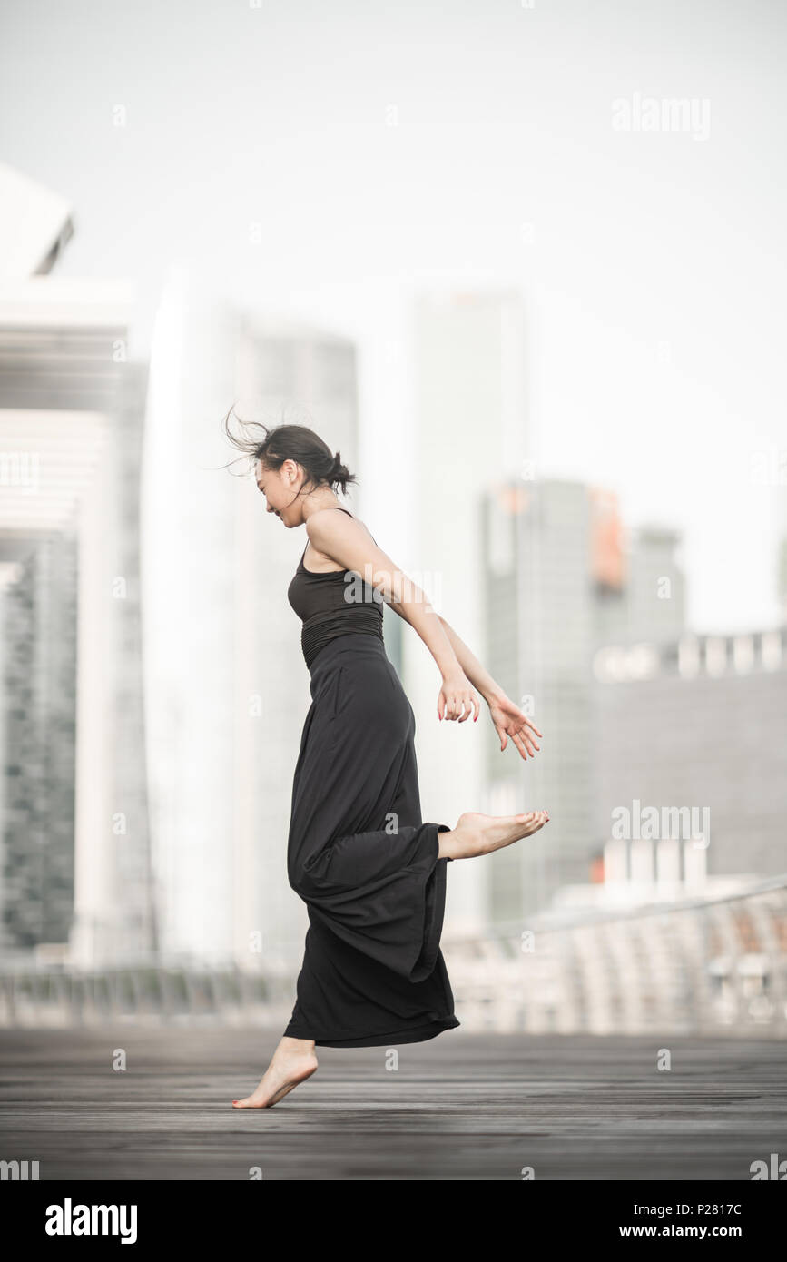 Beautiful Young Girl Dancing on a bridge Stock Photo - Alamy