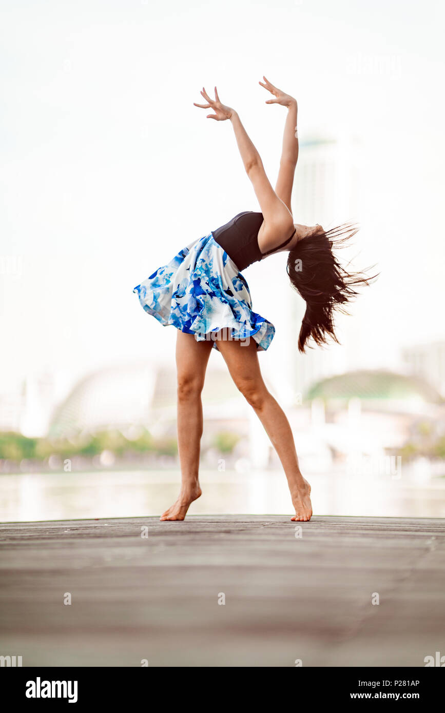 Beautiful Young Girl Dancing in the City, with background of ...