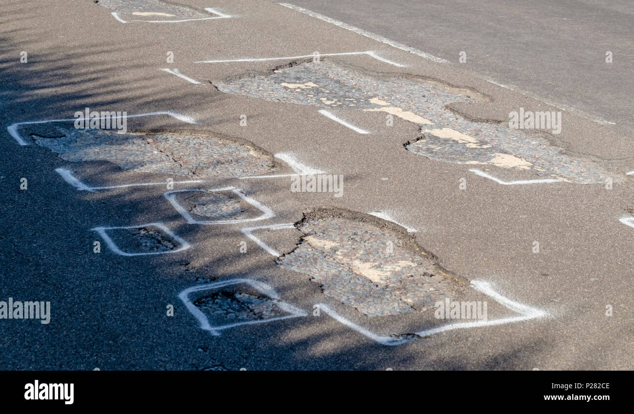 Potholes marked ready for repair, markings are starting to fade Stock ...