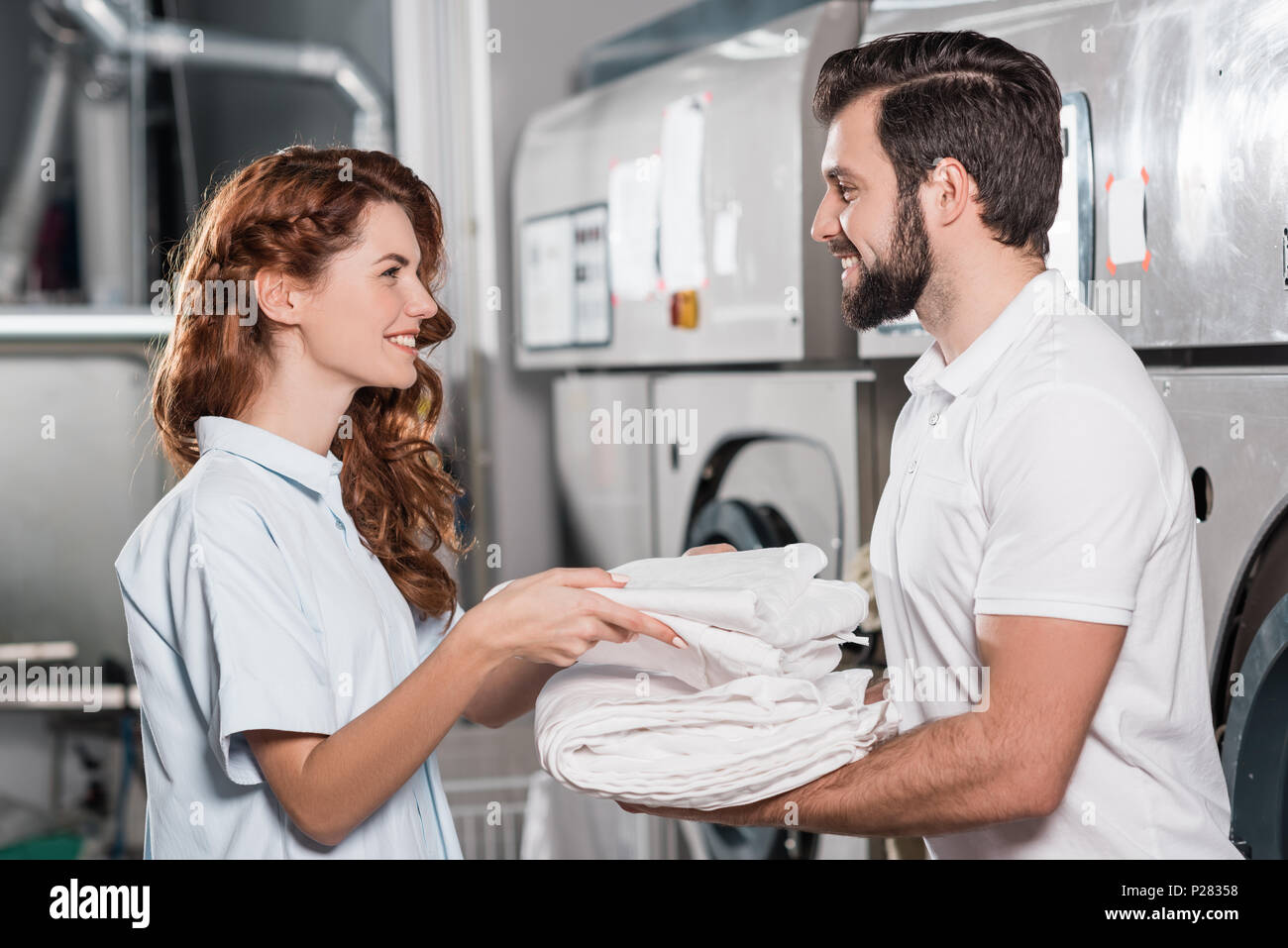 dry cleaning managers working together at laundry Stock Photo - Alamy