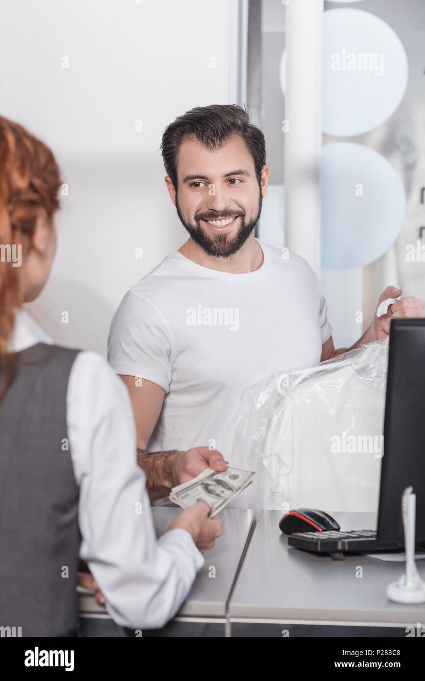 dry cleaning manager taking money for work from customer Stock Photo ...