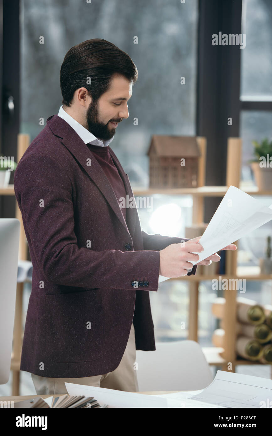 handsome architect working with blueprints in modern office Stock Photo ...