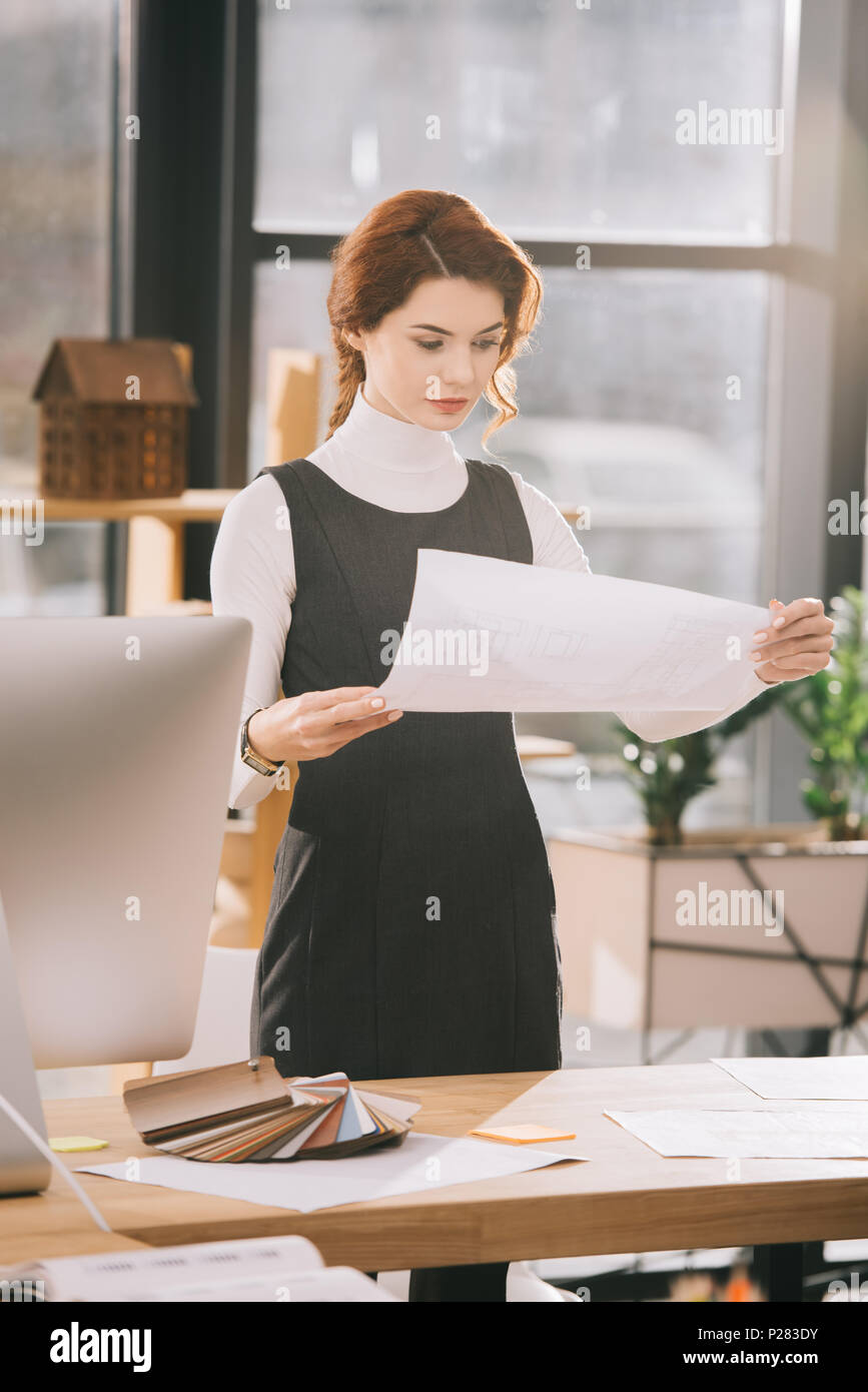 female architect working with blueprints at workplace in office Stock ...