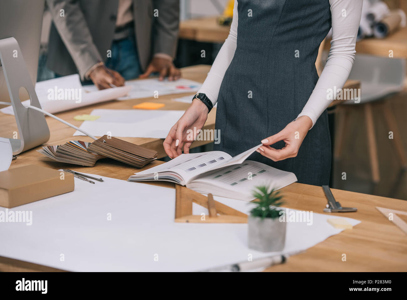 Female architect building plans discussing hi-res stock photography and ...