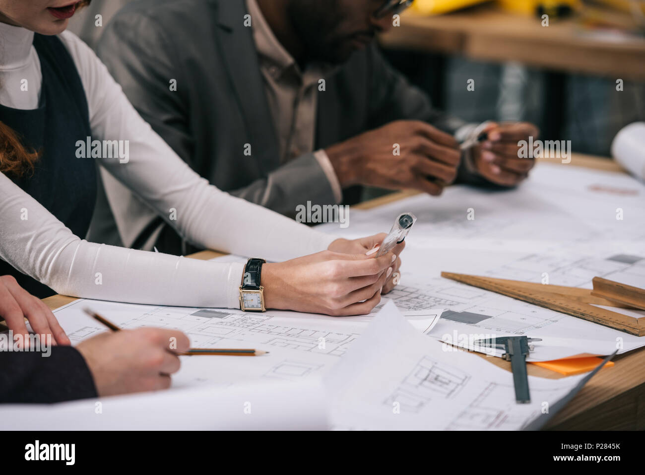 cropped shot of architects drawing building plans together Stock Photo ...