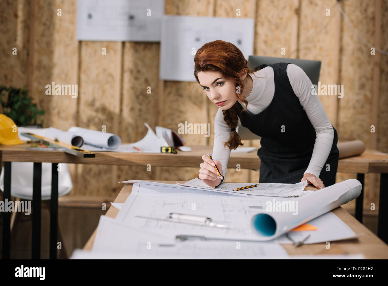 beautiful young female architect discovering building plans Stock Photo ...