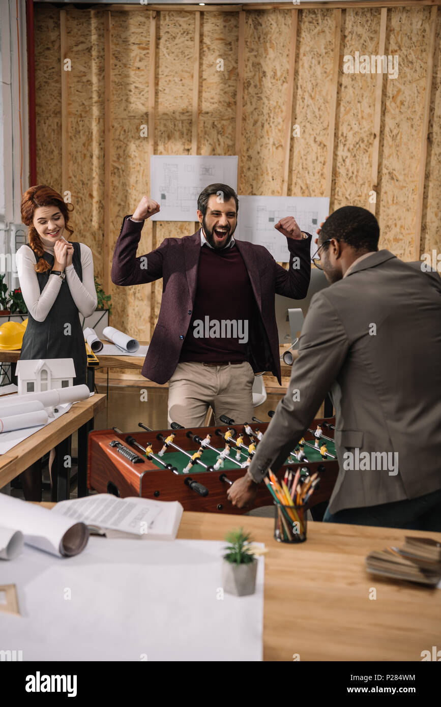 young architects playing table football at modern office Stock Photo ...