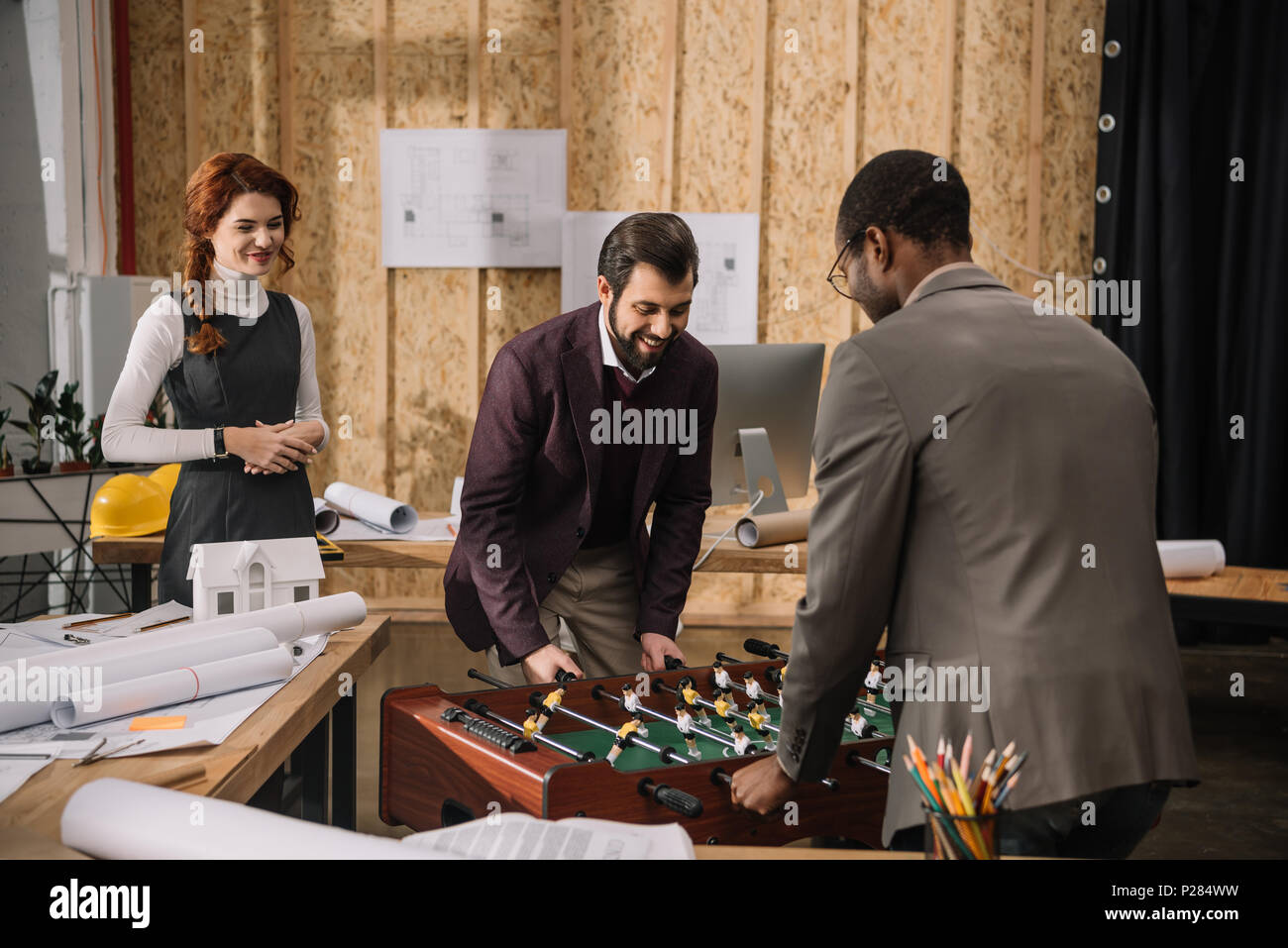 architects playing table football at modern office Stock Photo - Alamy