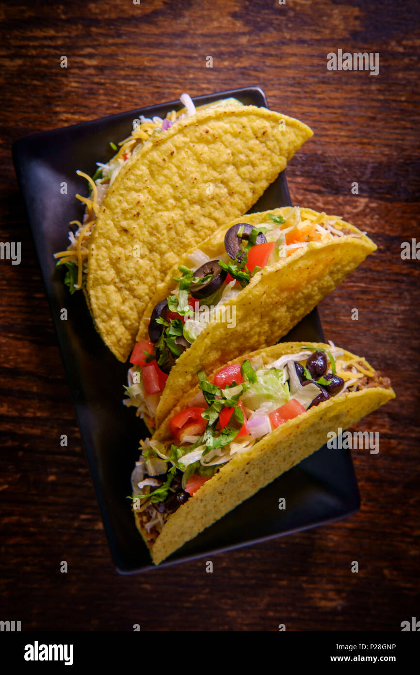 Mexican beef tacos loaded with toppings including olives shredded ...