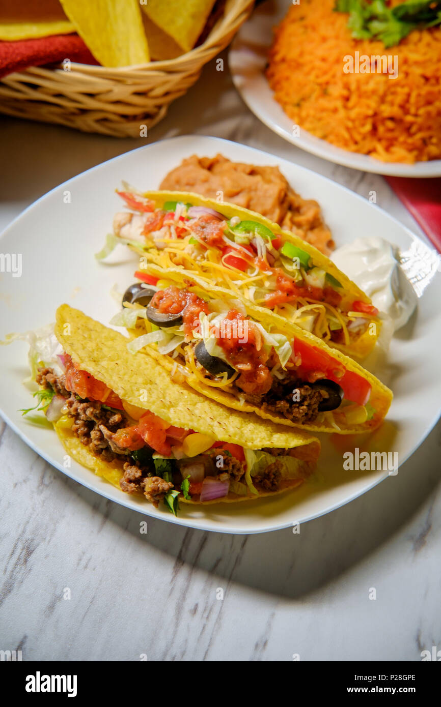 Mexican beef tacos loaded with toppings including olives shredded ...