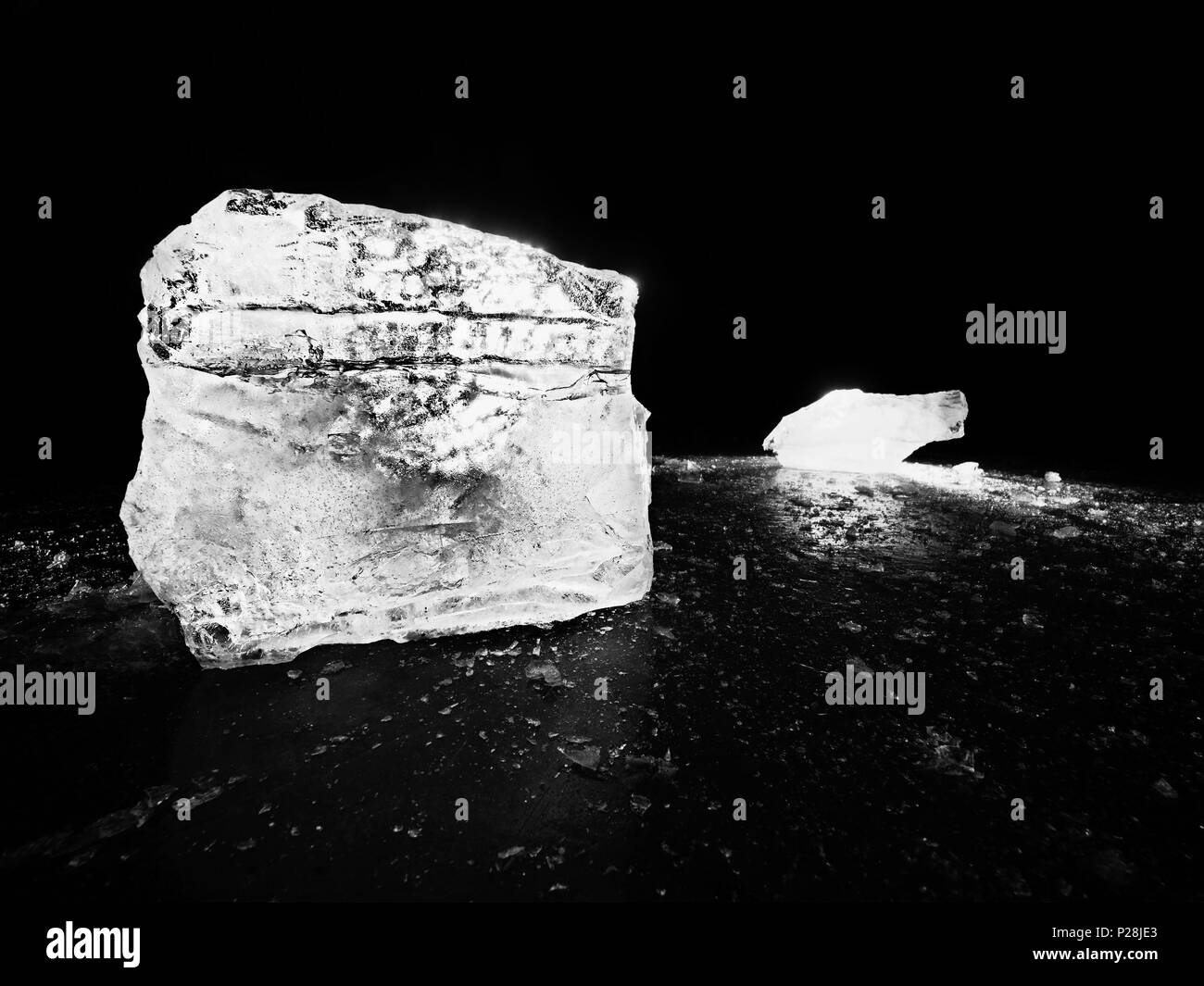 Cut ice. Crushed cubes lighted with strong backlight. Silent bay with ...