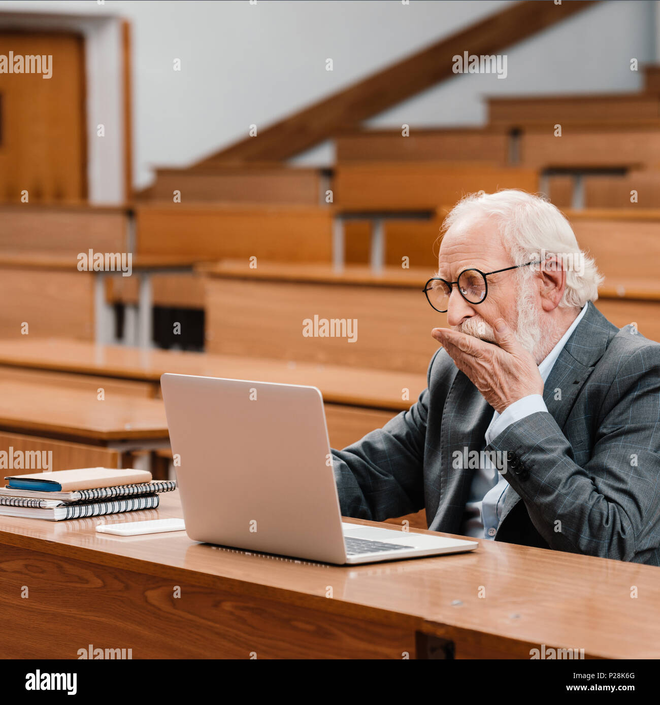 grey hair professor yawning in empty lecture room Stock Photo - Alamy