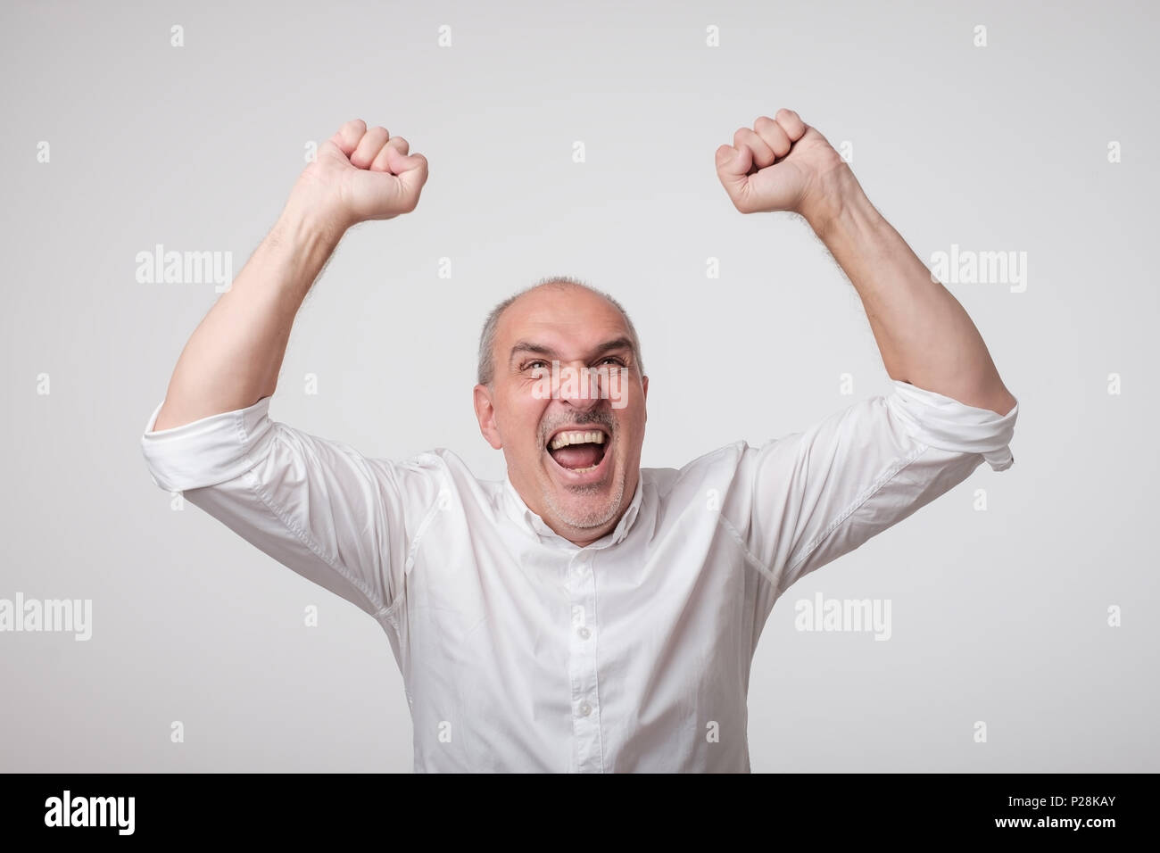 Mature man celebrating winning hi-res stock photography and images - Alamy