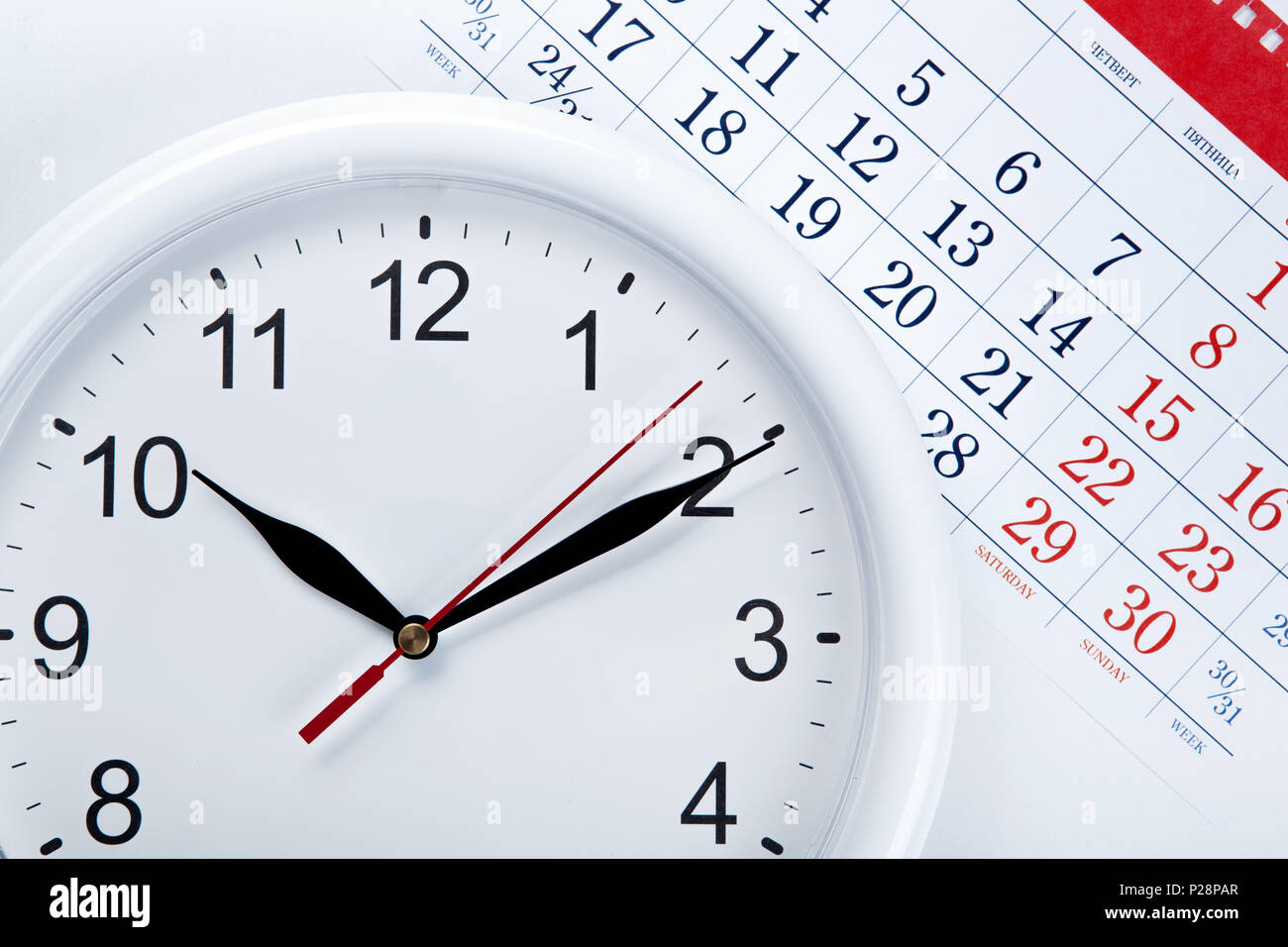 clock face and calendar sheet with numbers closeup Stock Photo - Alamy