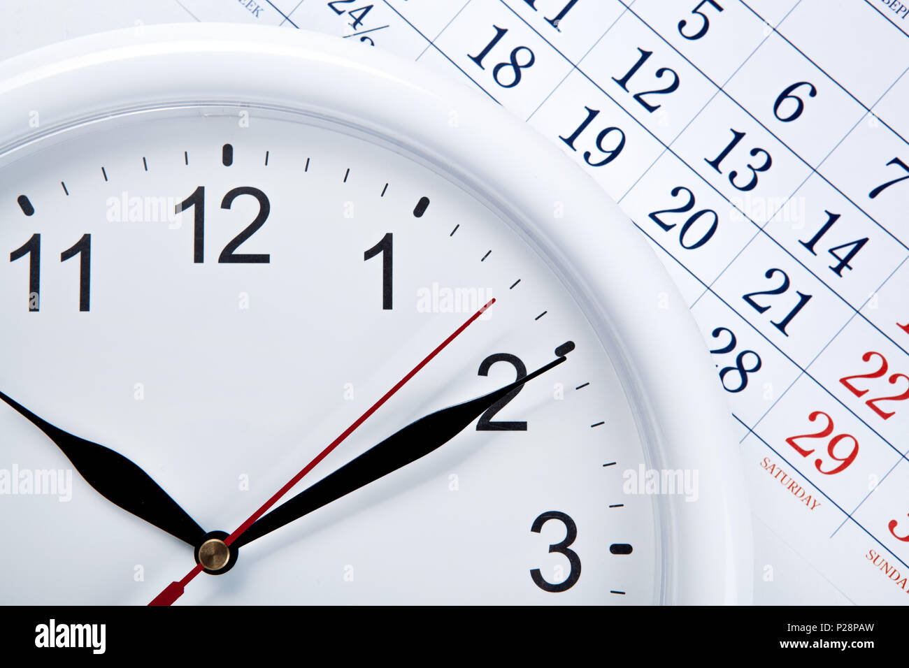 clock face and calendar sheet with numbers closeup Stock Photo - Alamy