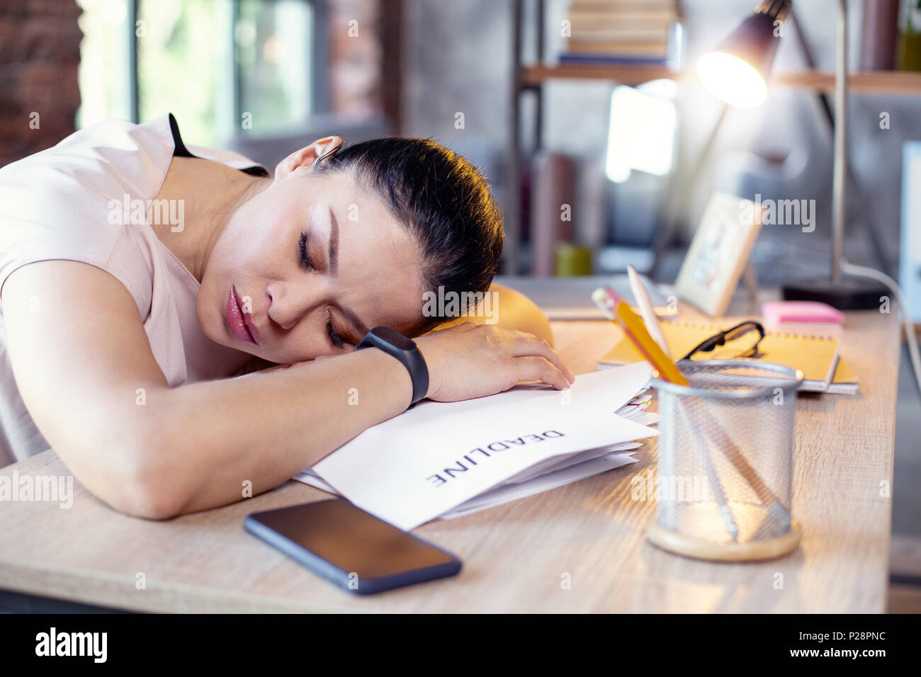 Calm female employee sleeping at work Stock Photo - Alamy