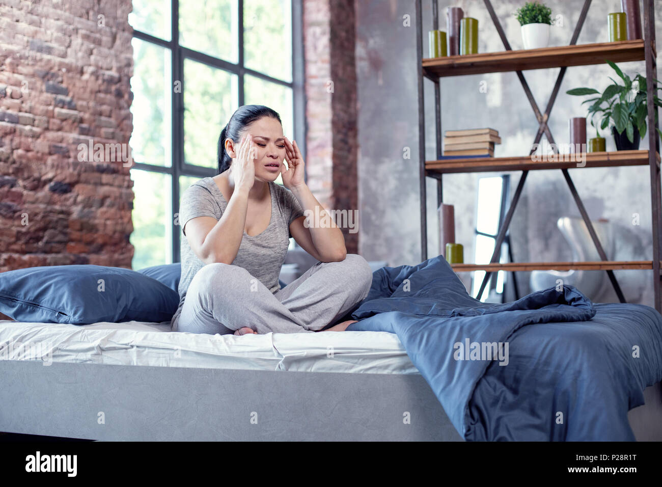 Exhausted worn woman relieving symptoms Stock Photo - Alamy