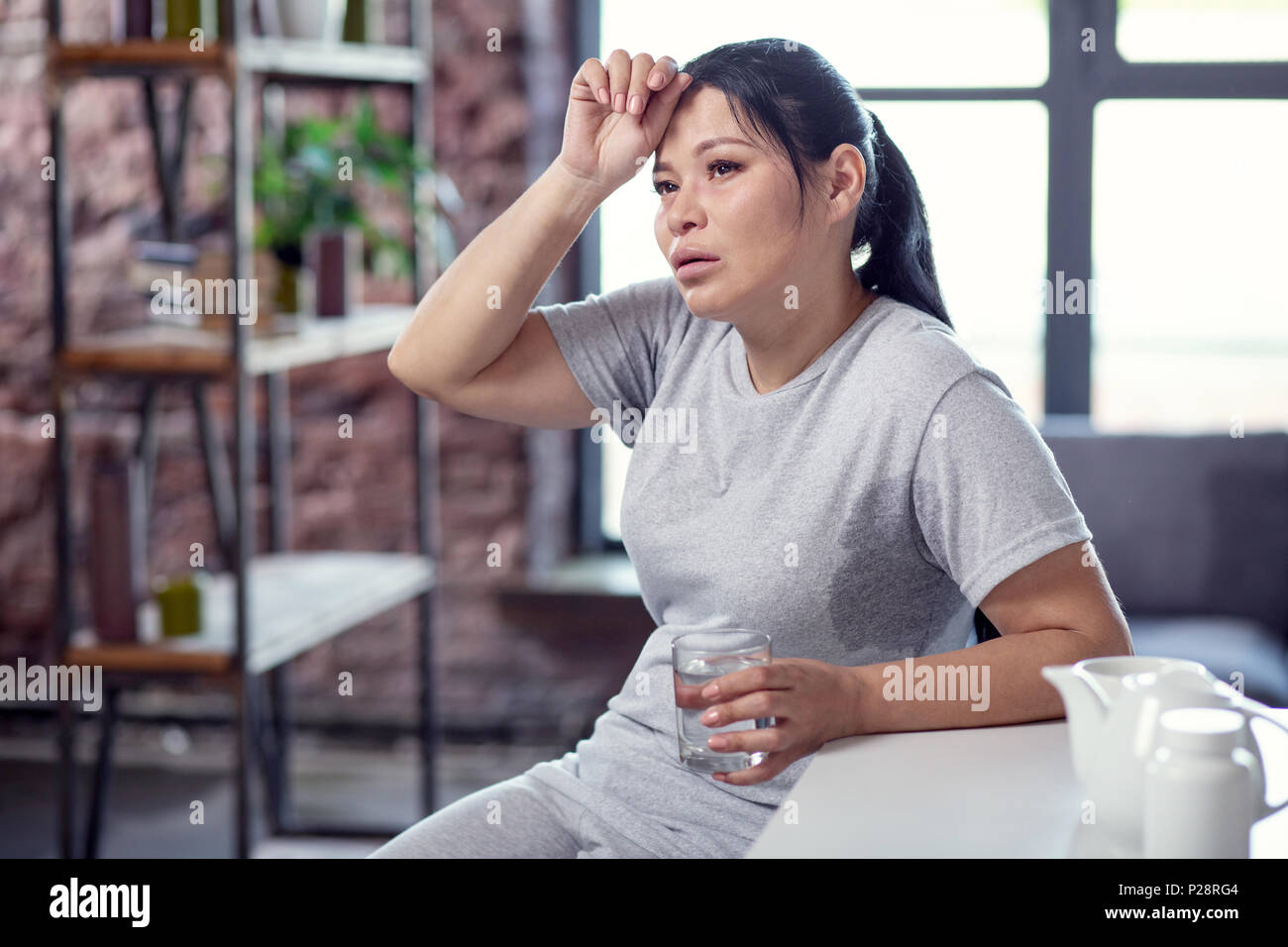 Worn nice woman sweating Stock Photo - Alamy
