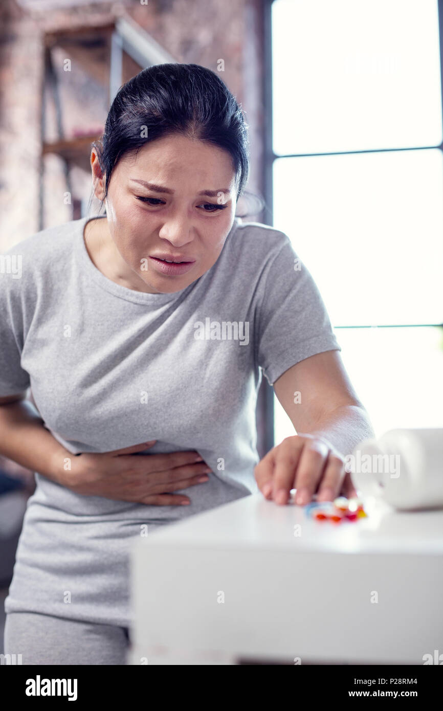Pretty ill woman taking drugs Stock Photo - Alamy