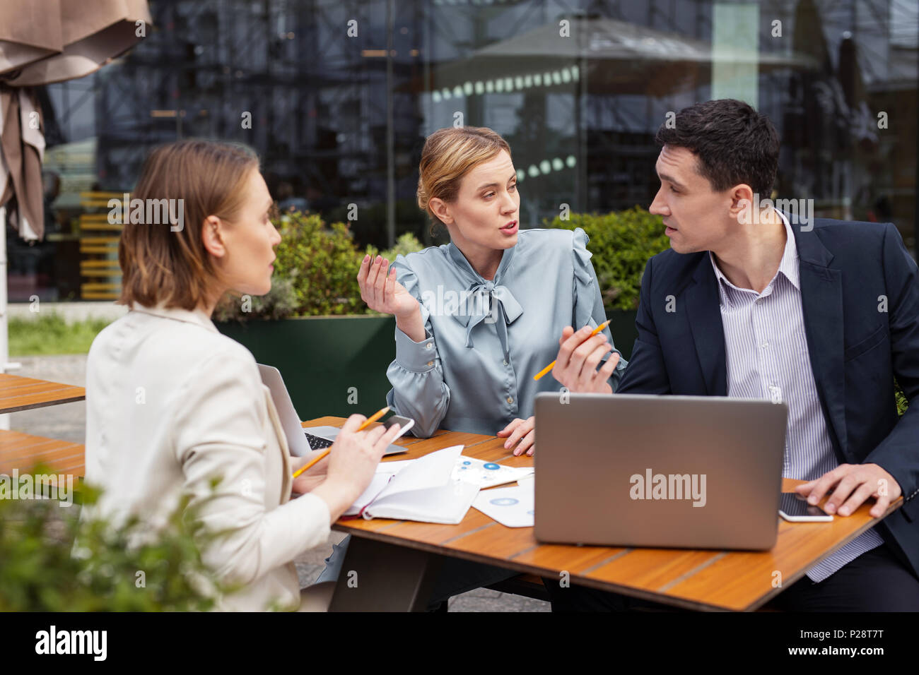 Three managers having dispute about business proposal Stock Photo - Alamy